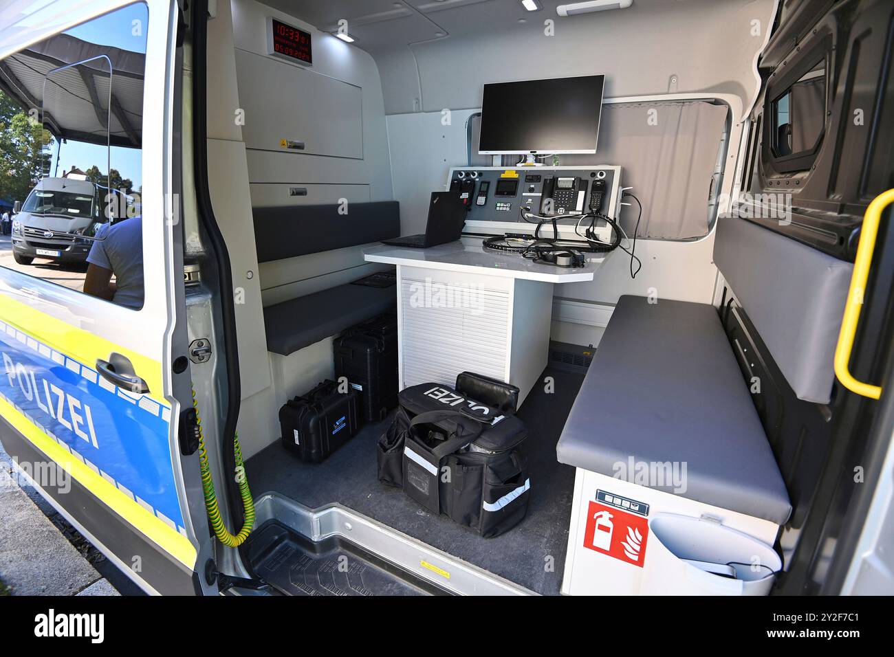 View through the open sliding door of a police patrol car into the ...