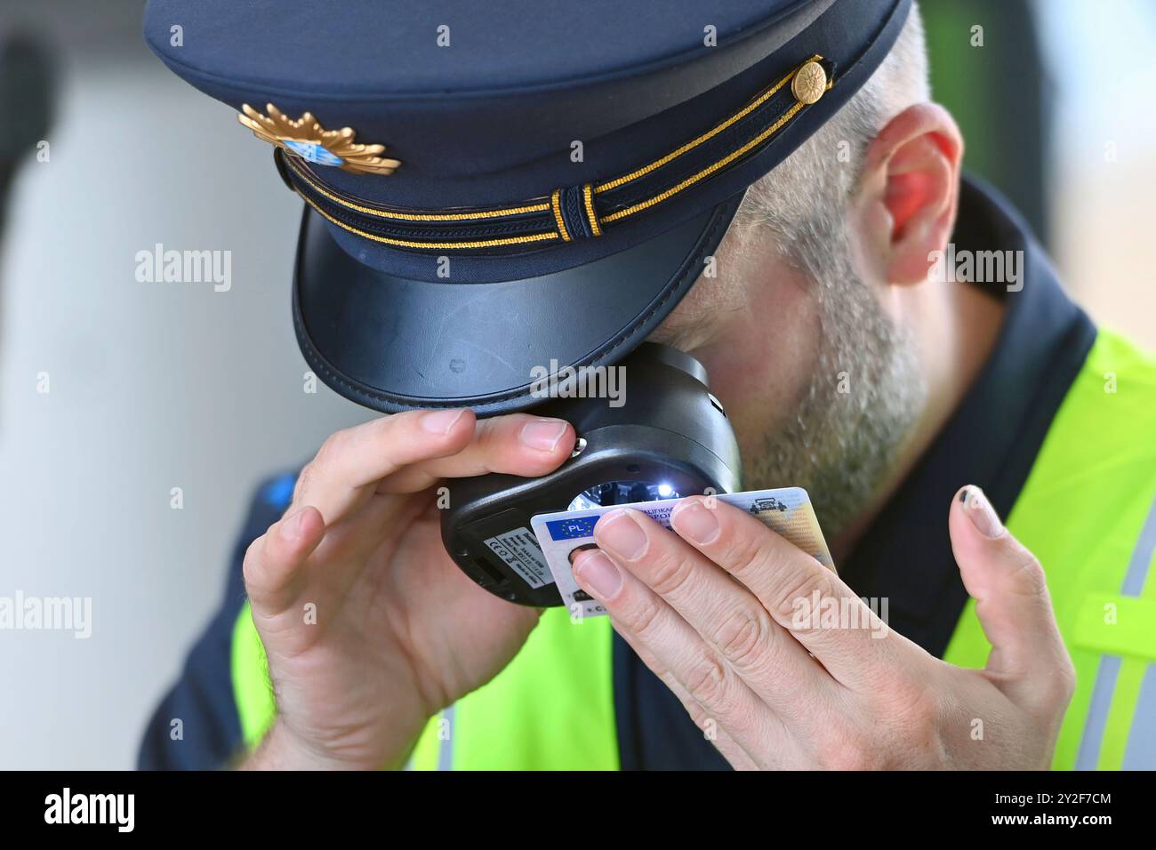 Border police officer, police officer checks the authenticity of a ...