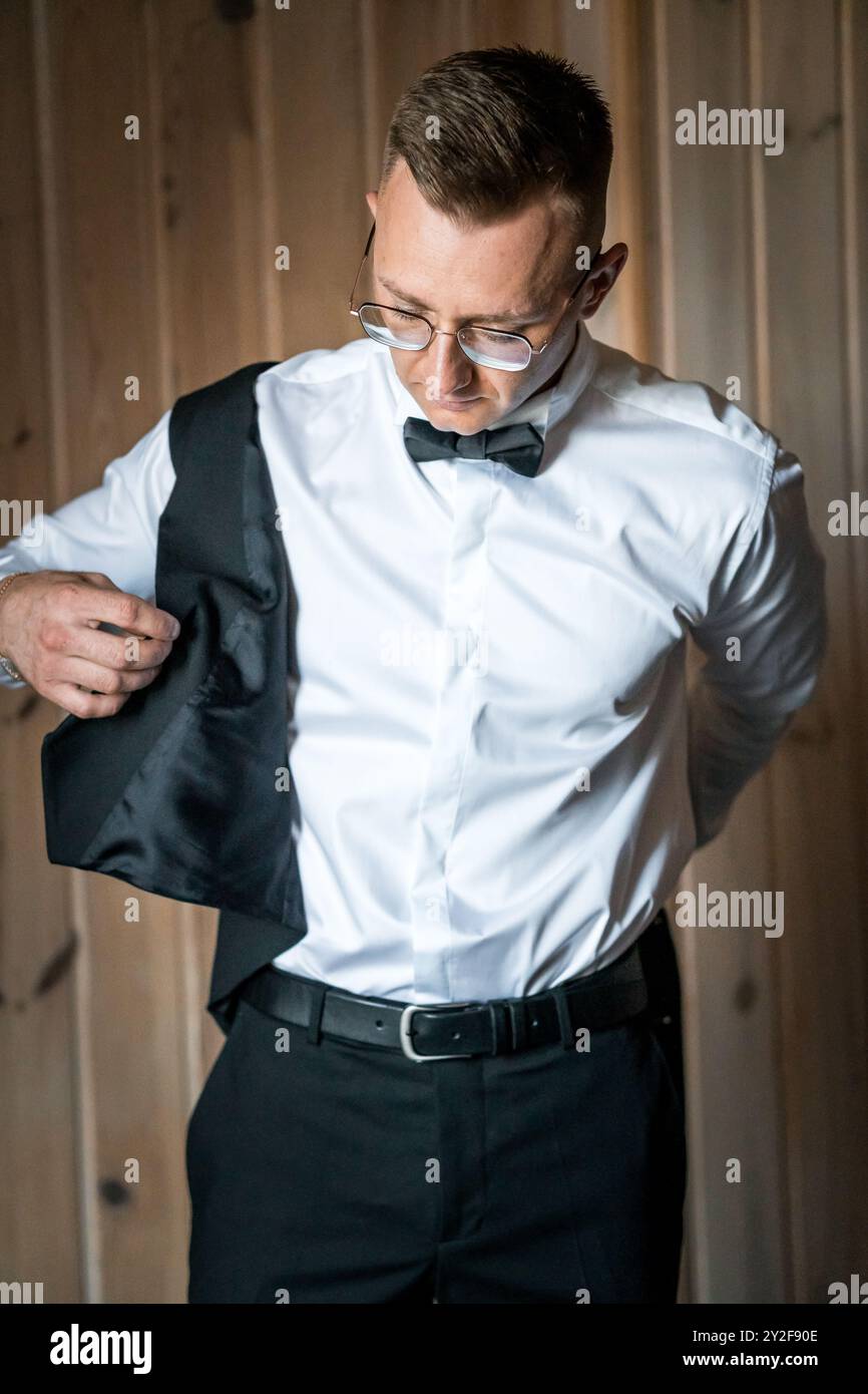 Elegant Man Adjusting Suit Jacket in Stylish Formal Attire Against ...