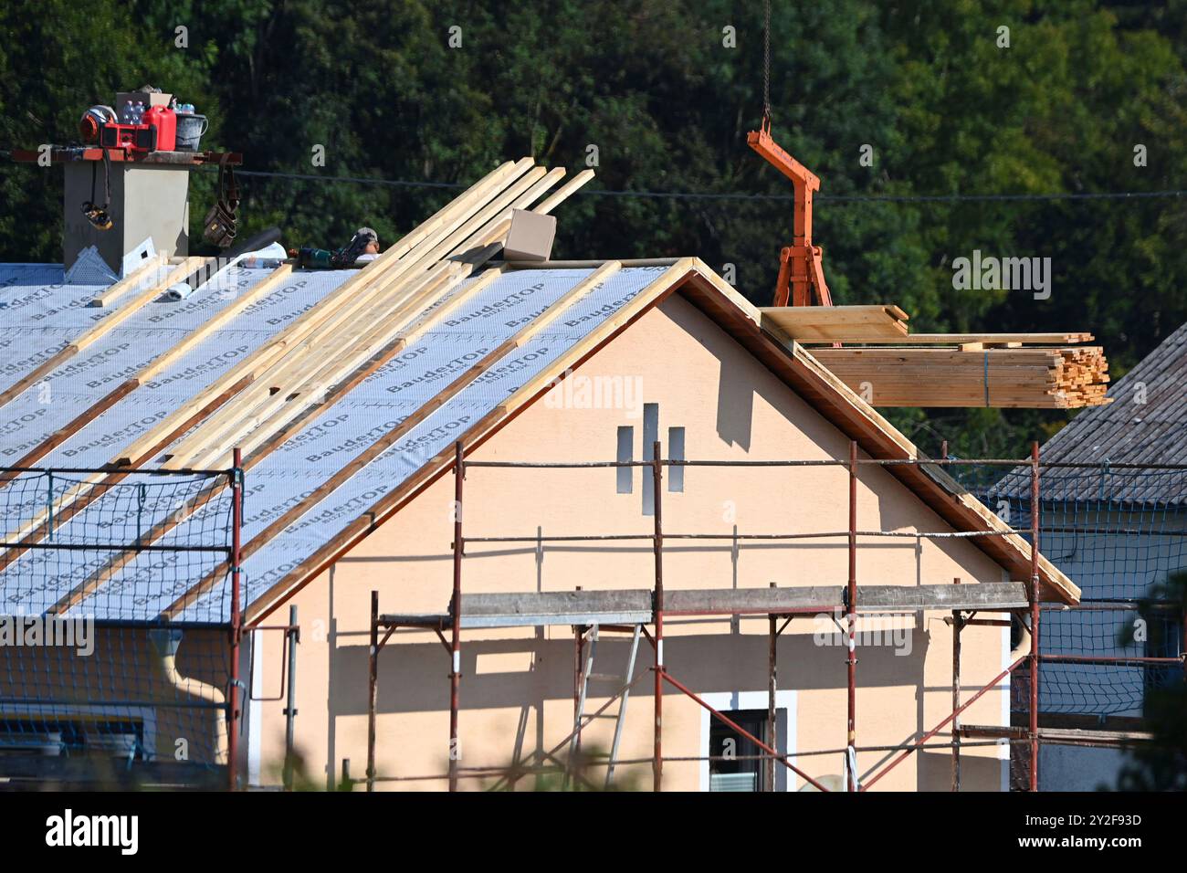 Roof renovation. An older house gets a new roof, wood, roof battens ...