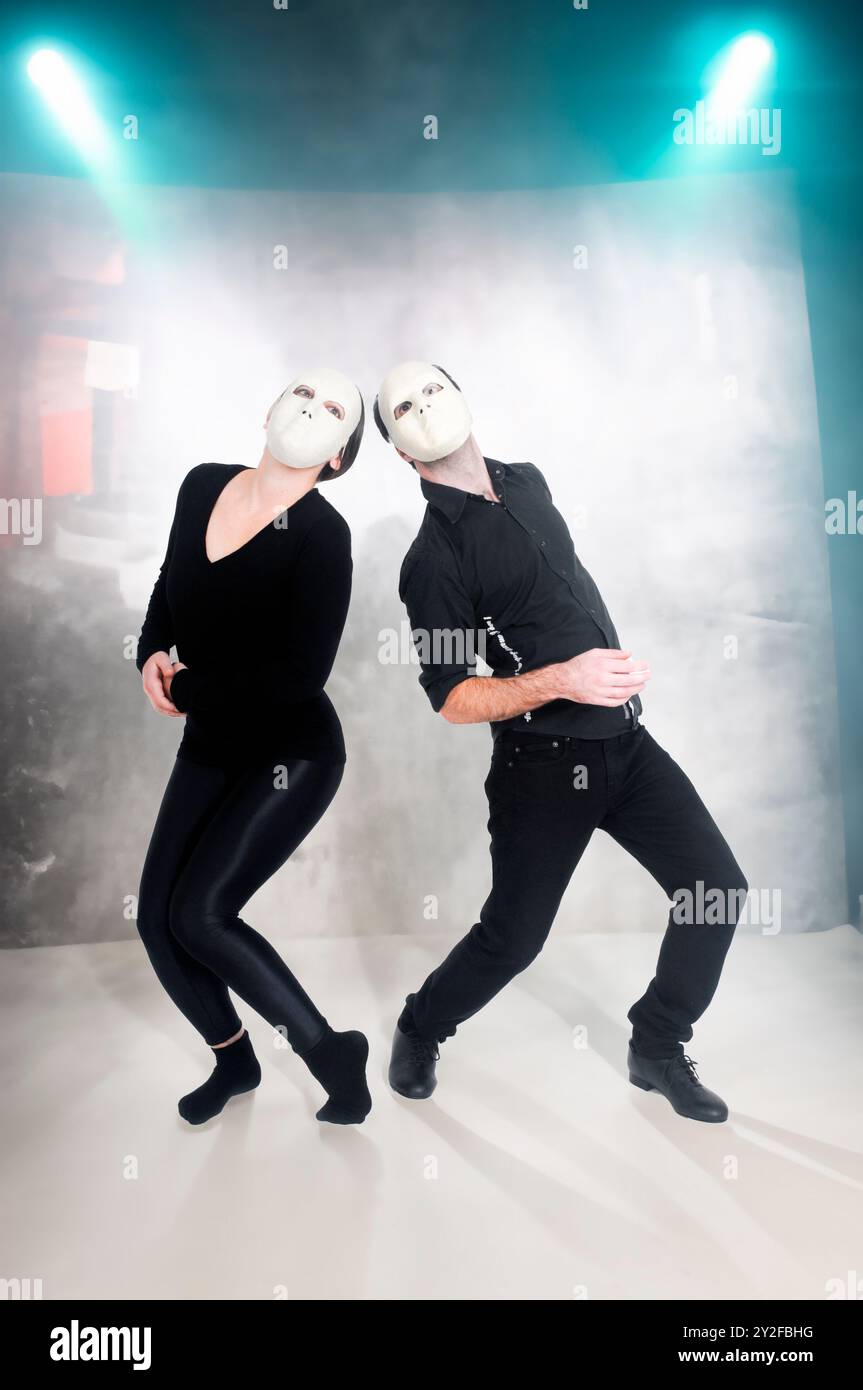 Digitally enhanced image of Masked actors in a physical theatre with a ...