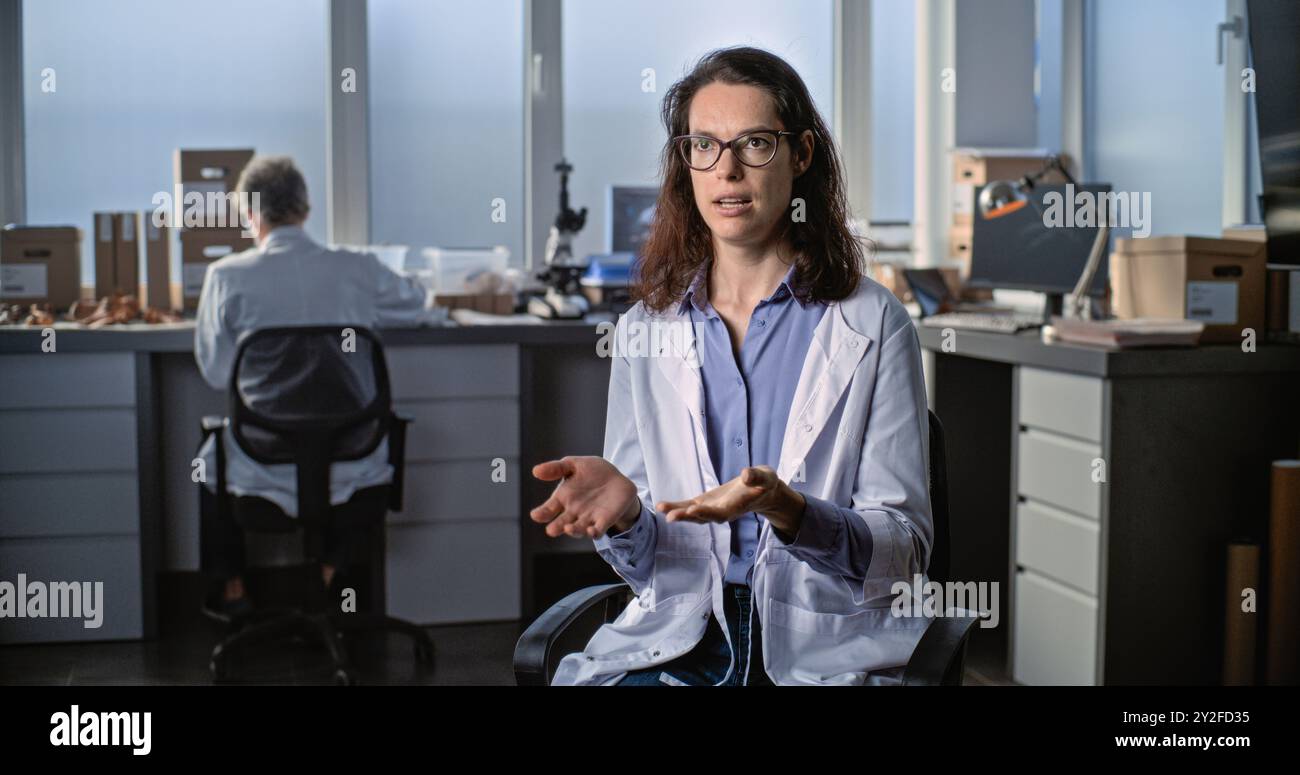 Female scientist talks colleague works hi-res stock photography and ...