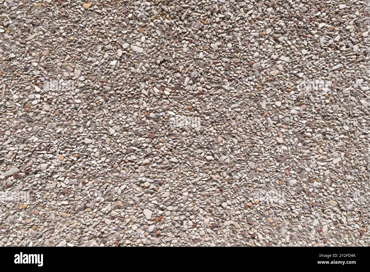 textured surface made of small, irregularly shaped stones embedded in a ...