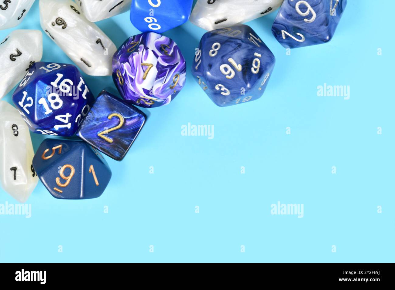 Different roleplaying RPG dice in upper corner of blue background with ...