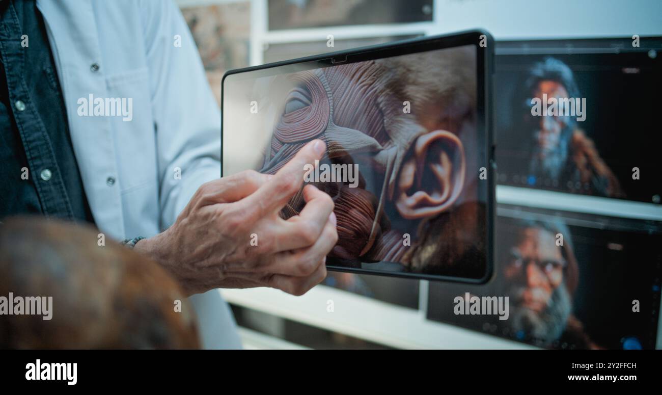 Archaeologists study anatomy of fossil skull using tablet computer with ...