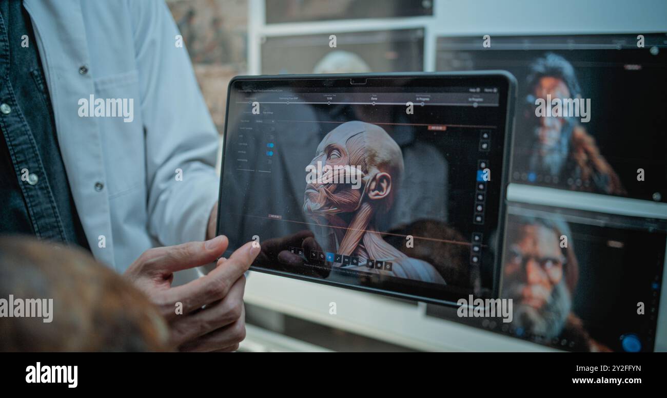 Archaeologists study anatomy of fossil skull using tablet computer with ...