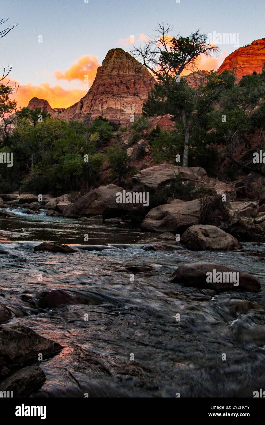 The majestic peak of the Watchman towering over the fast flowing Virgin ...