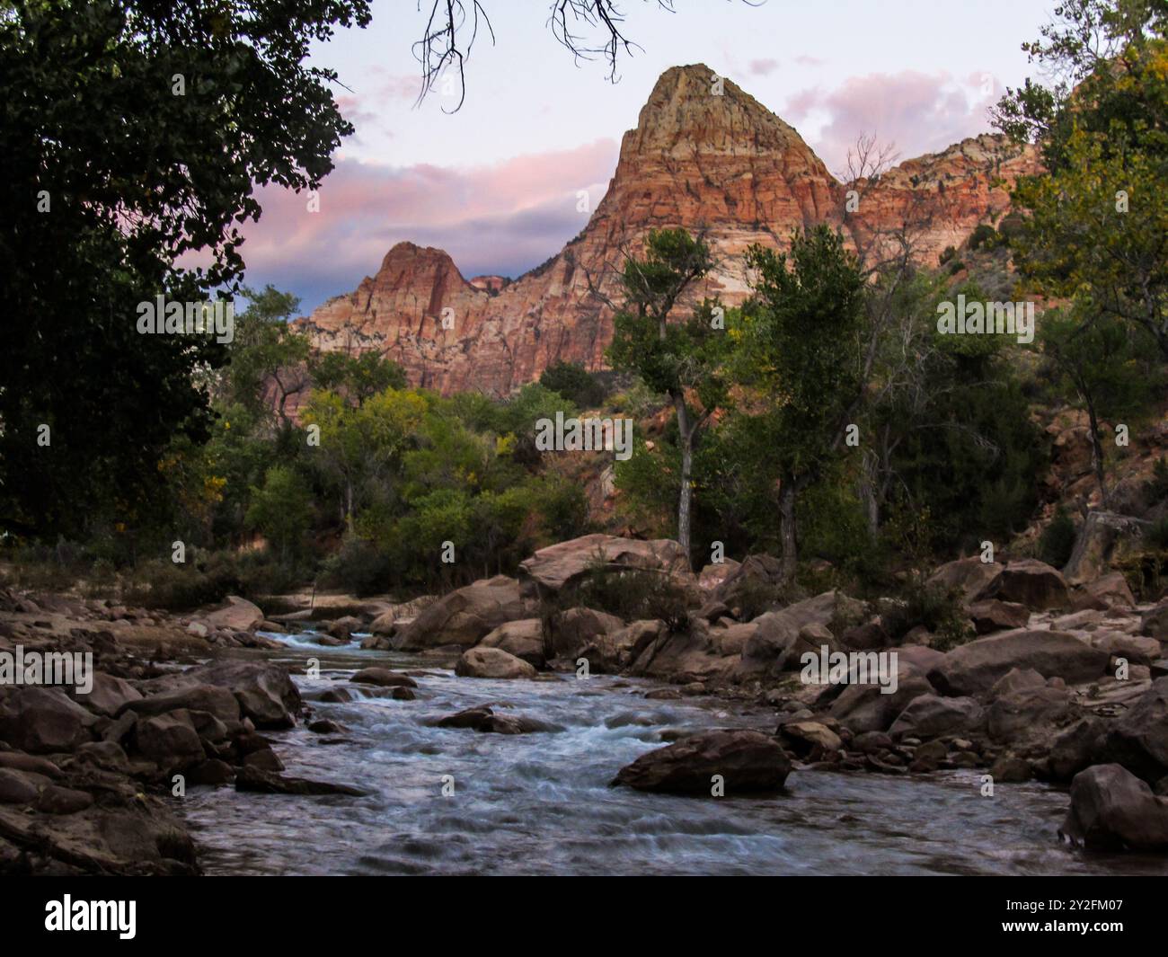 The majestic peak of the Watchman towering over the fast flowing Virgin ...
