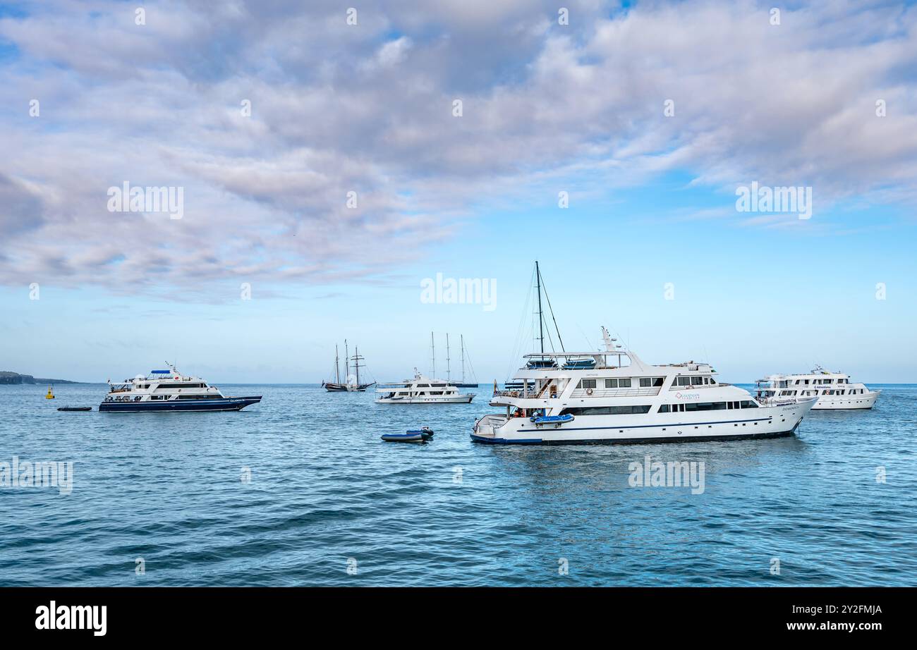 Tourist cruise ships and tall sailing ship moored in Puerto Ayora ...