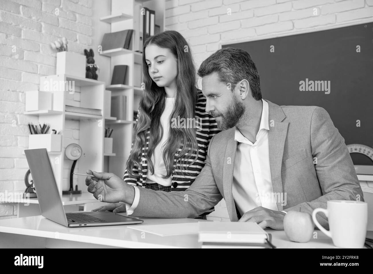 Teacher using laptop in Black and White Stock Photos & Images - Alamy