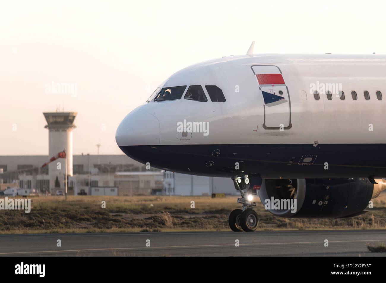 Airplane is on the runway at sunset. Larnaca International Airport ...