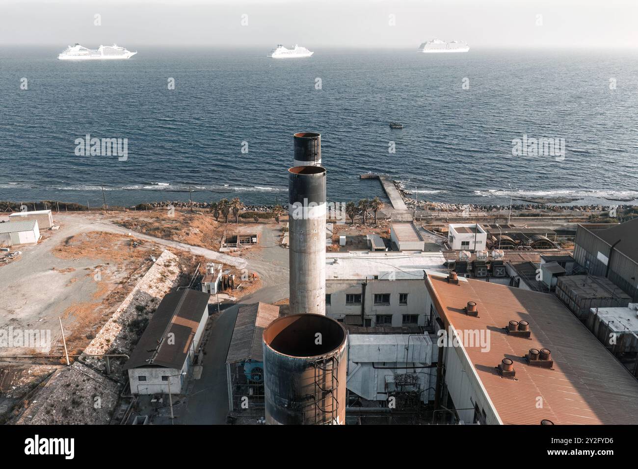 Chimneys of Moni Power Station with cruise ships on the horizon ...