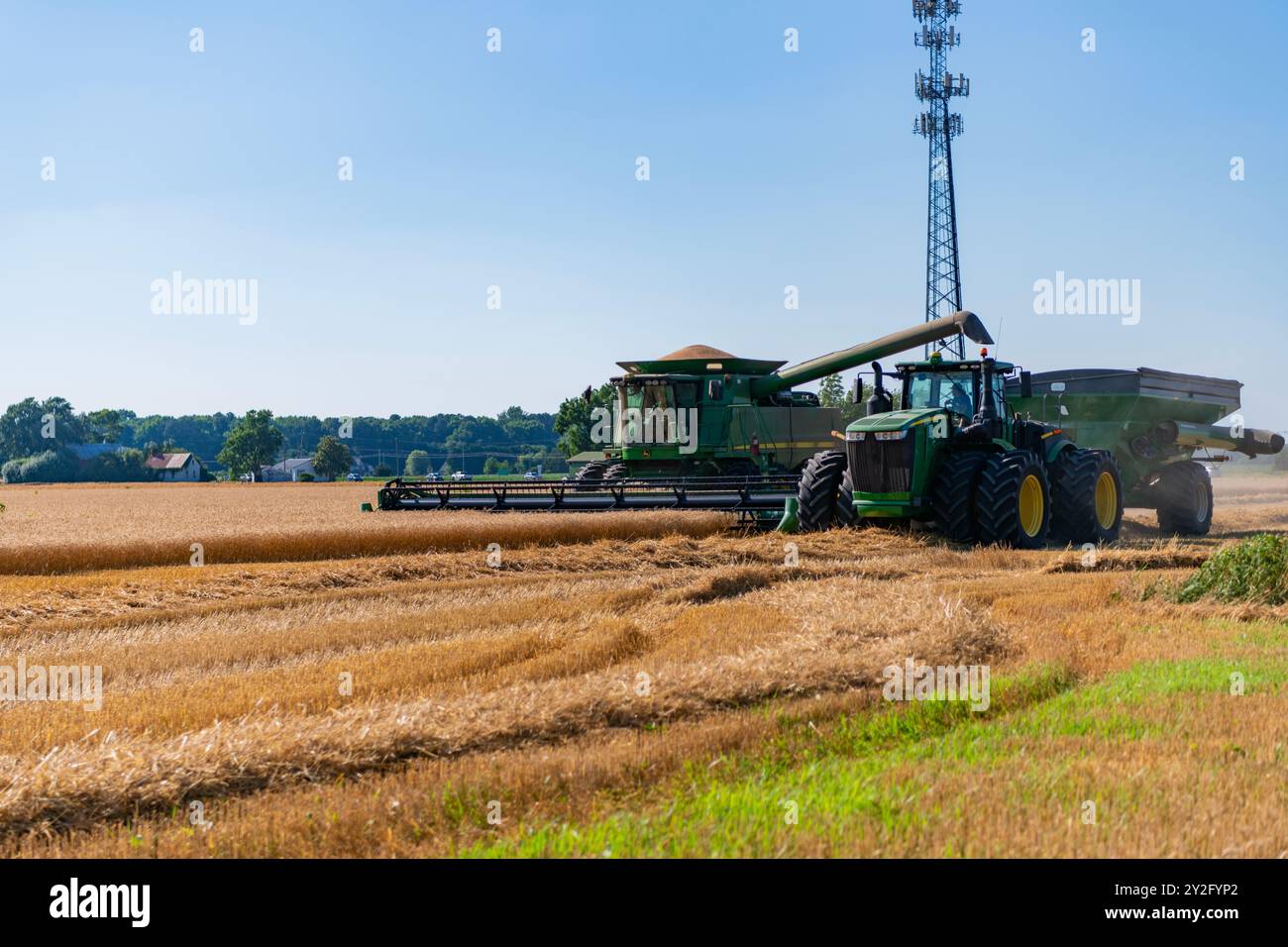 Crop harvesting. Agriculture and farming. Combine harvester and tractor ...