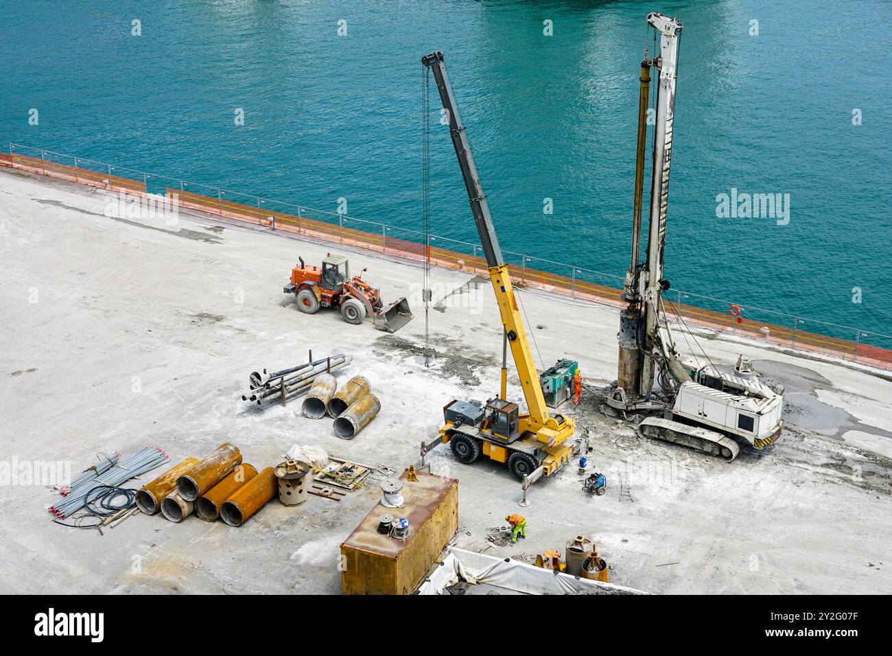 Installation of pile casings in the port quay, drilling rig, port ...
