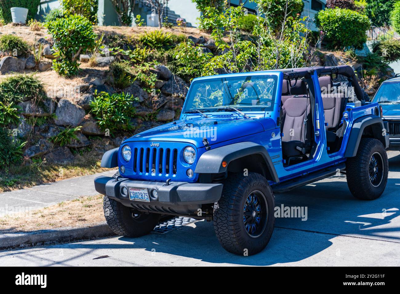 Seattle, WA, USA -July 3, 2024: jeep wrangler jk trail blue side corner ...