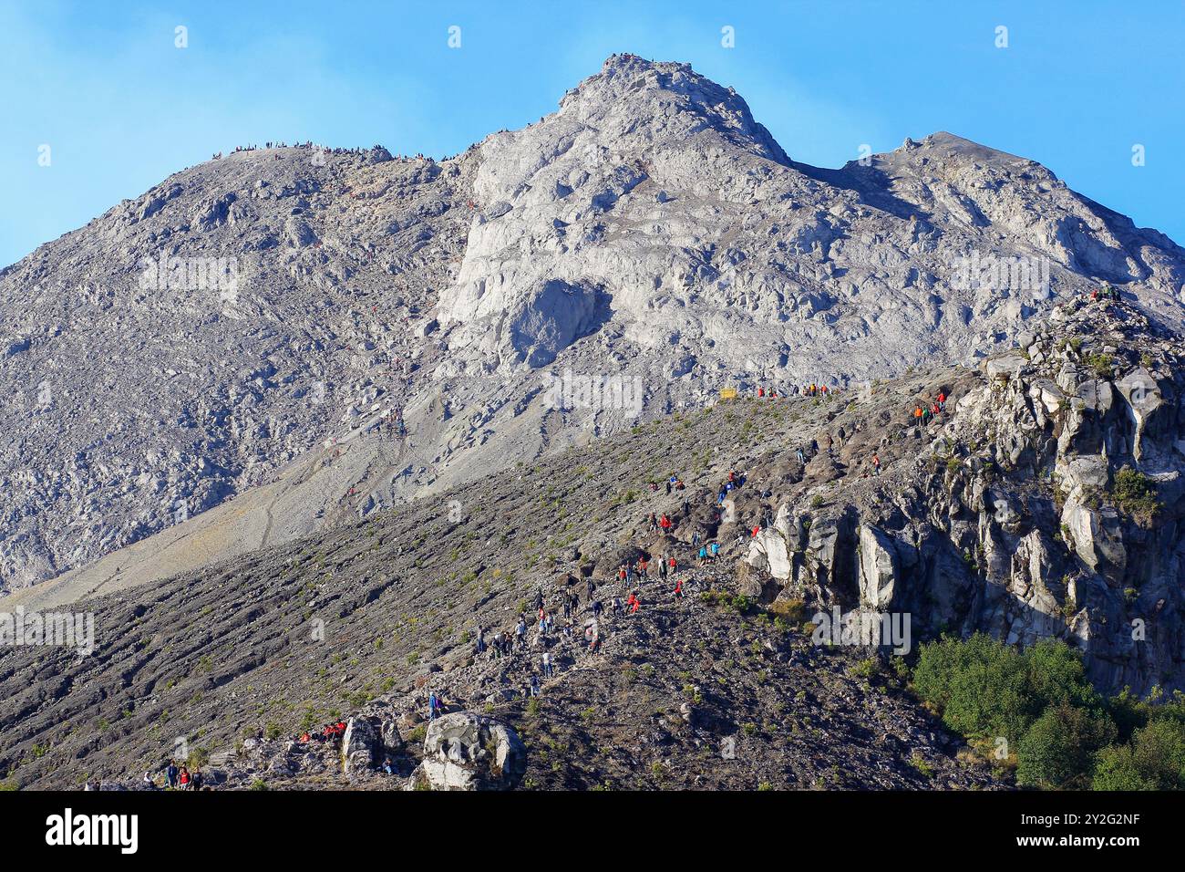 Mass climbing to the summit of Mount Merapi and line of climbers on the ...