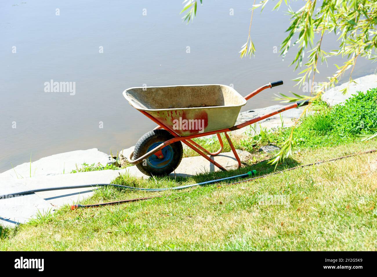 Wheel barrow at garden pond hi-res stock photography and images - Alamy