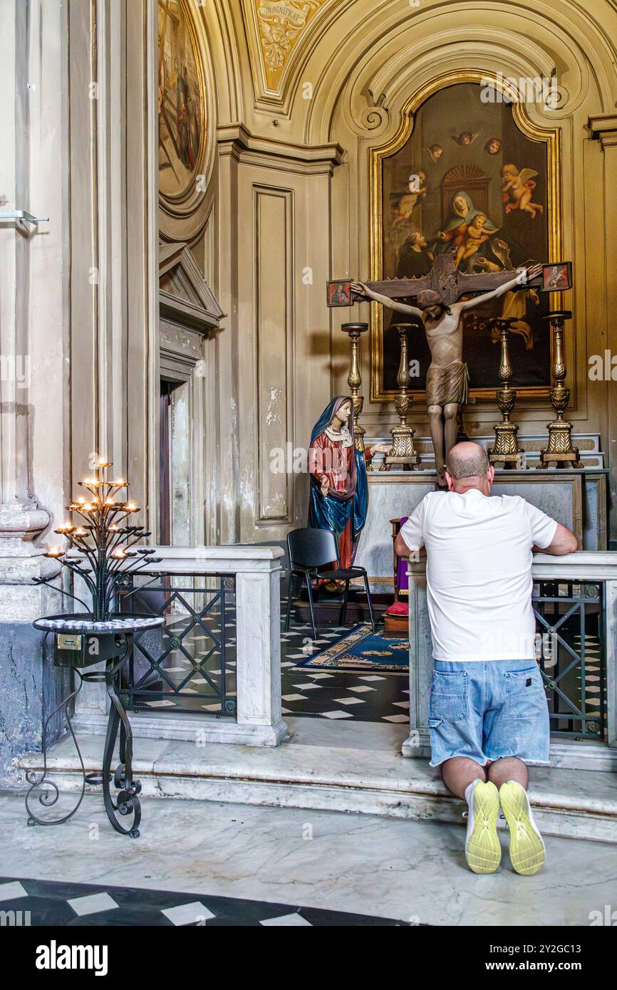 Man praying kneeling genuflecting hi-res stock photography and images ...
