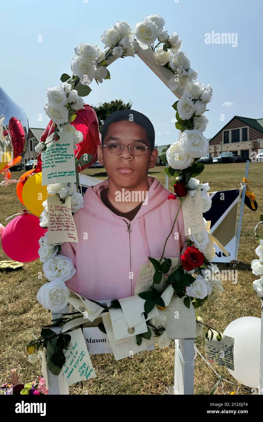 A poster with an image of shooting victim Mason Schermerhorn is ...