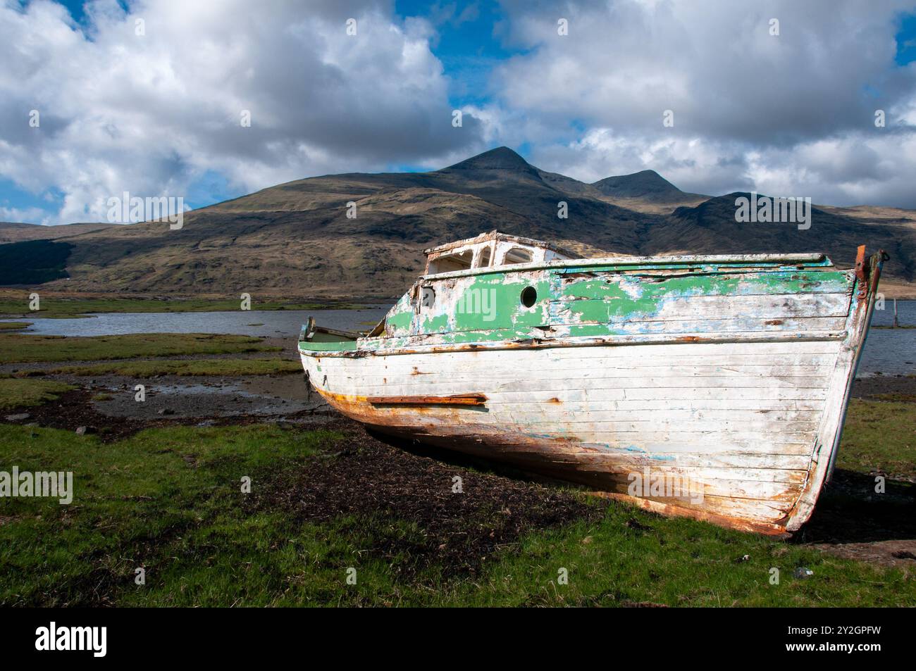Old boat on land in front of a Scottish Munro Stock Photo - Alamy