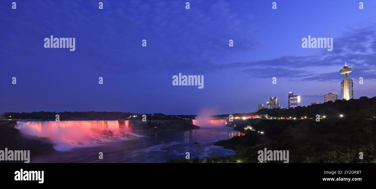 Aerial view of Niagara Falls illuminated on dusk and Niagara River ...