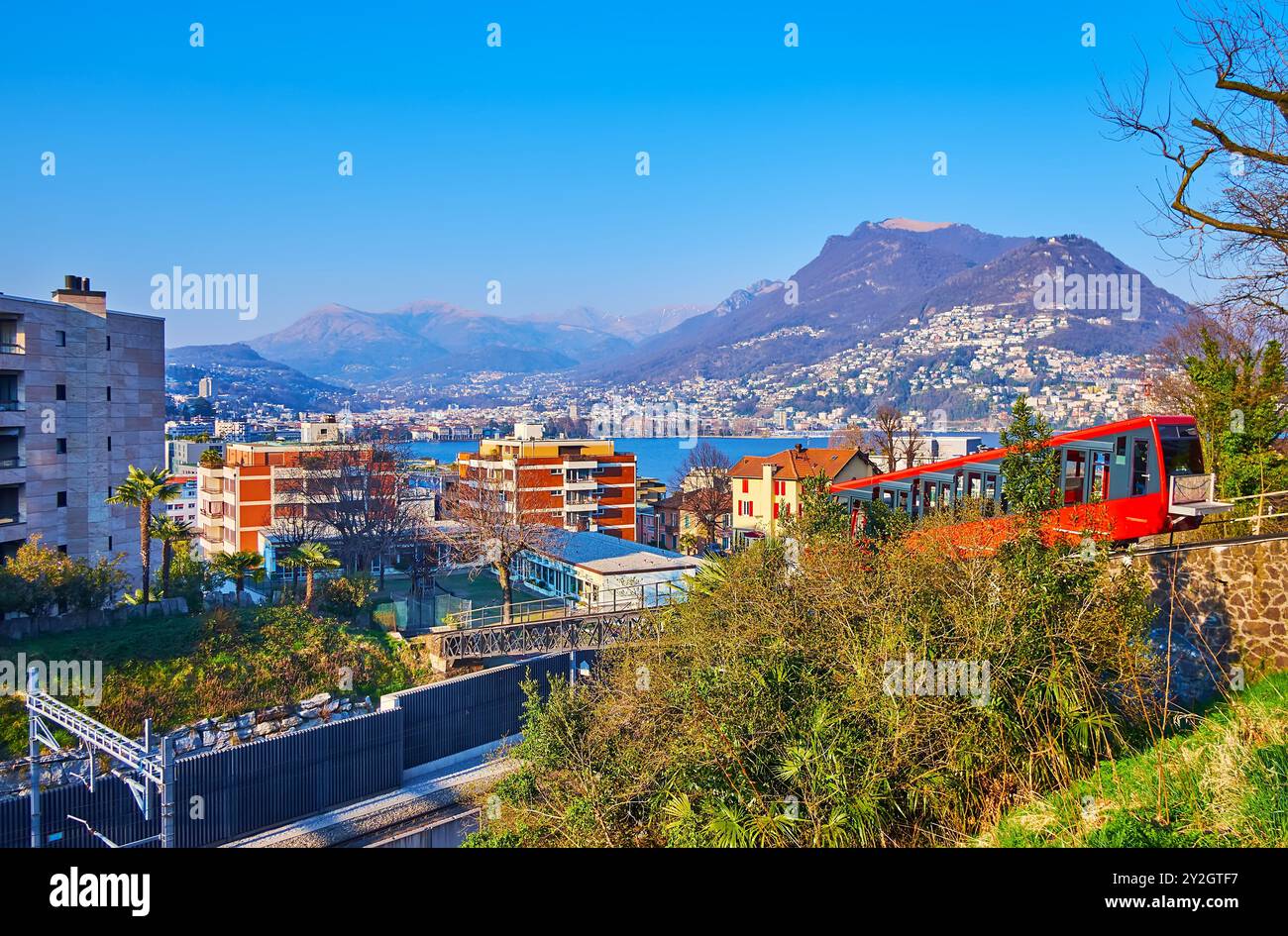 The scenic Alpine landscape with Monte Bre, Lake Lugano and riding ...