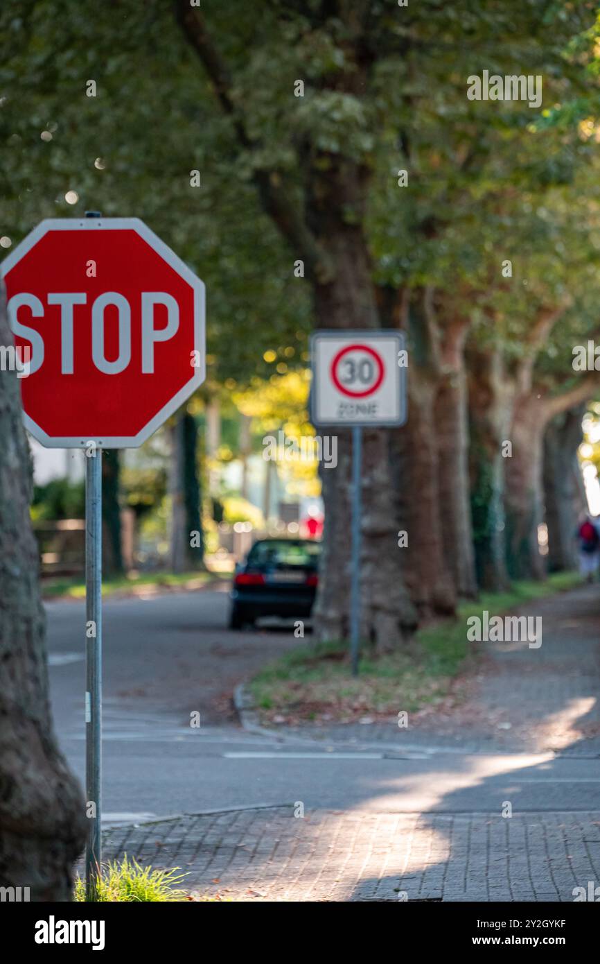 A stop sign on Europa Street and a 30 km/h limit sign in the back Stock ...