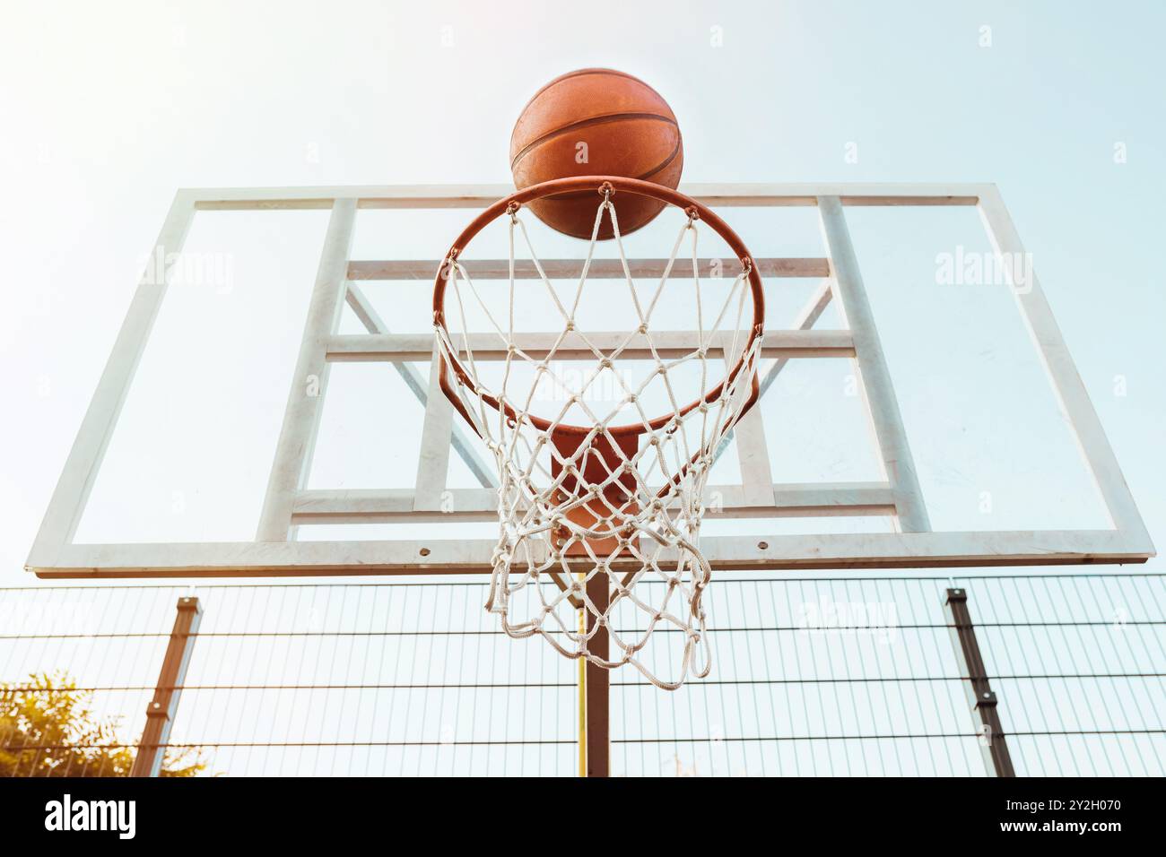 Action shot of basketball going through basketball hoop and net Stock ...