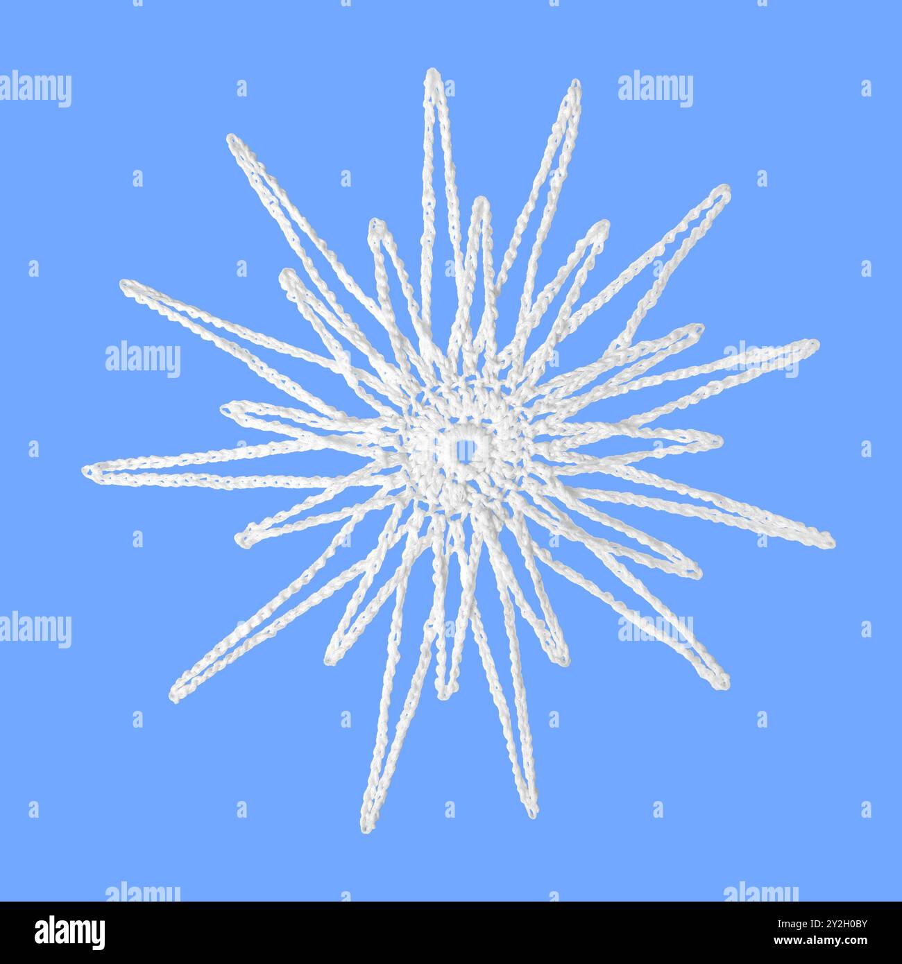 Knitted snowflake isolated on blue background. Mockup for your text and ...