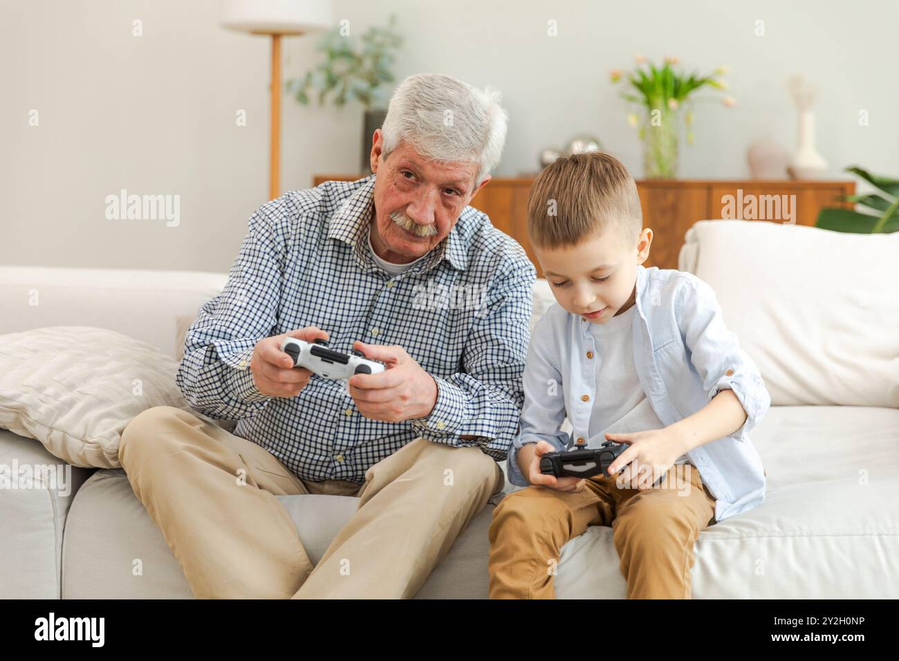 Happy family. Old senior man grandfather boy grandson playing video ...
