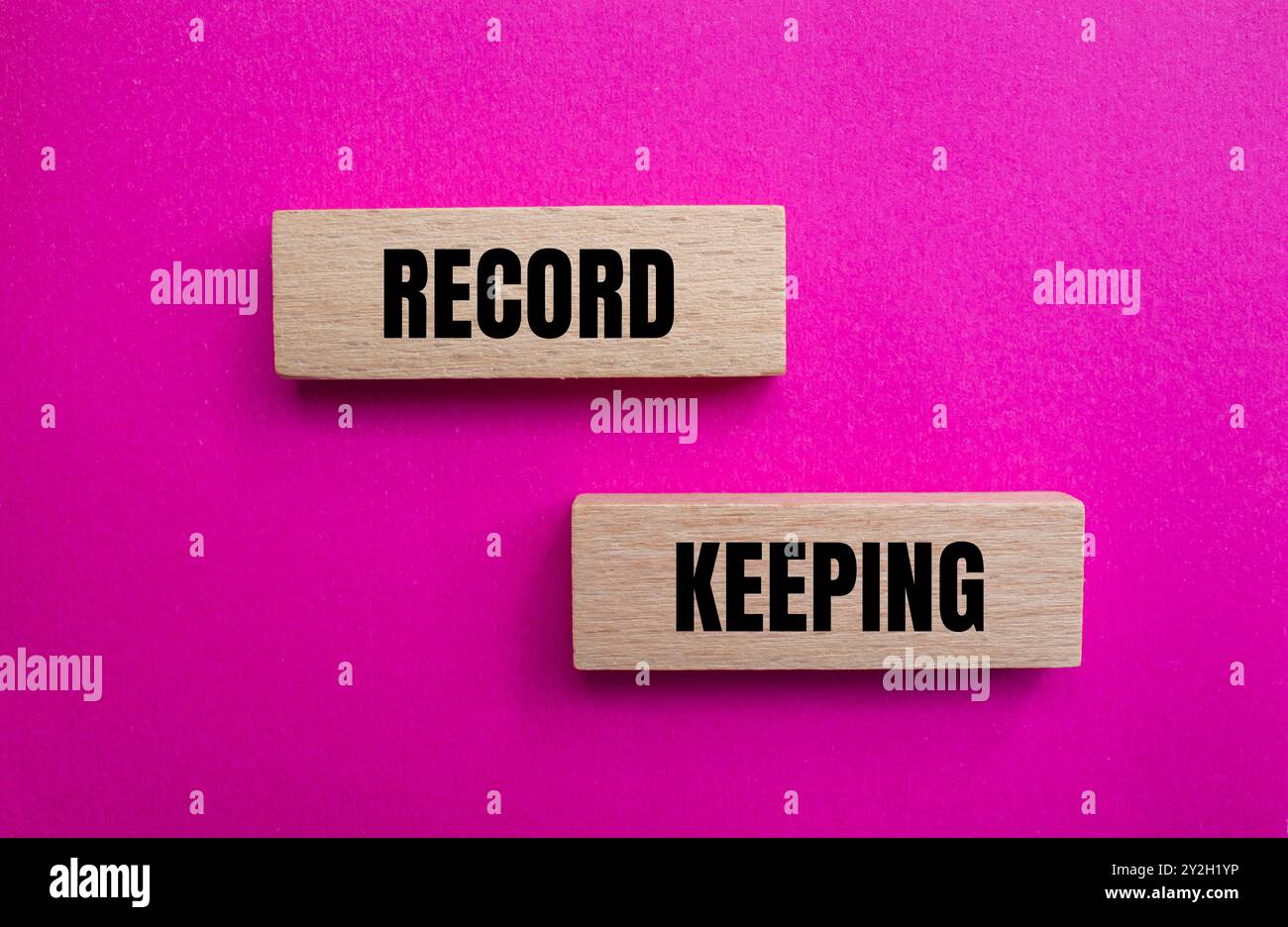 Record keeping message written on wooden blocks with pink background ...