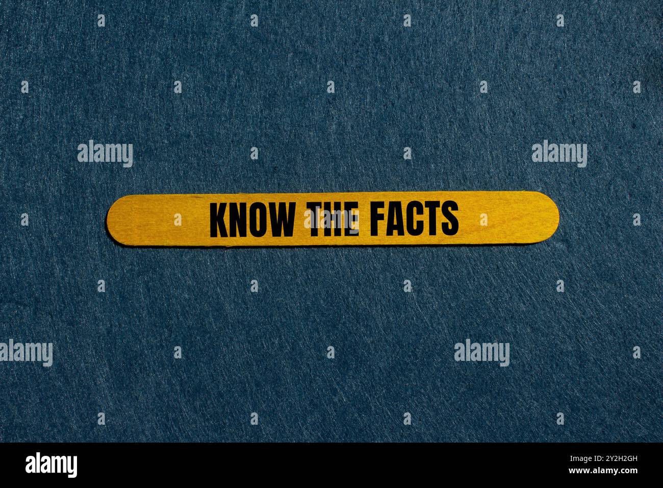 Know the facts message written on yellow wooden stick with gray ...