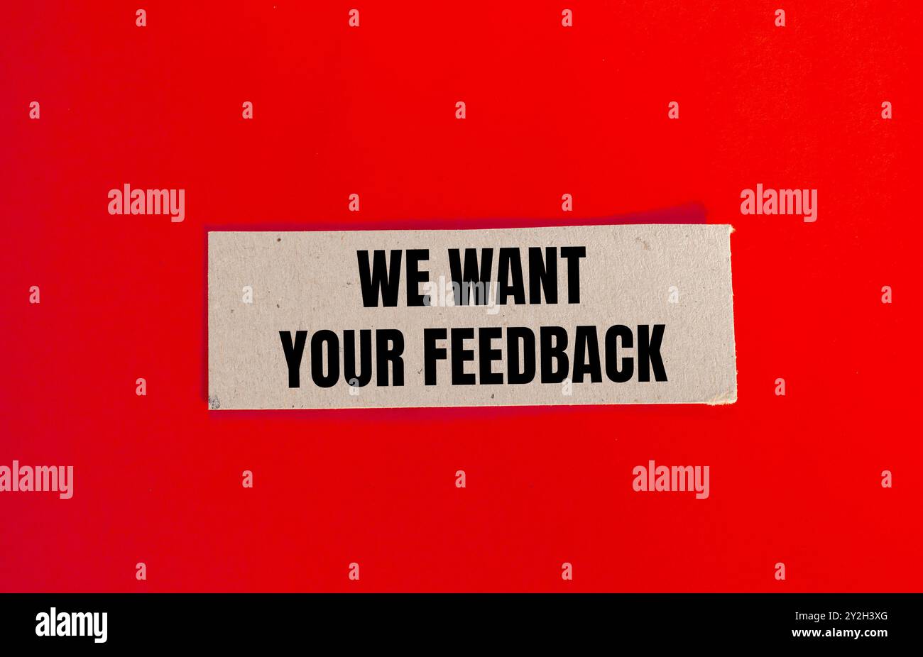 We want your feedback message written on paper piece with red ...
