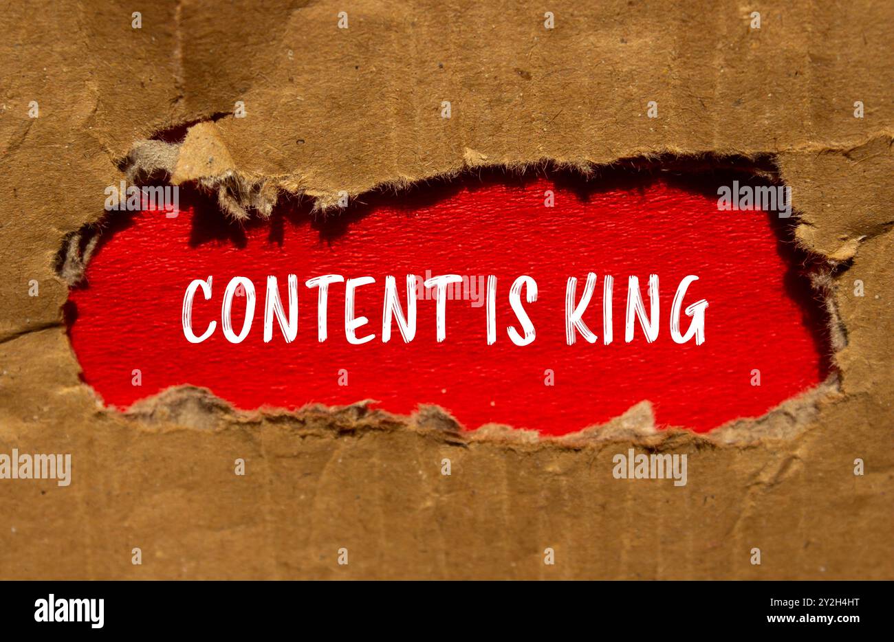 Content is king message written on torn cardboard paper with red background. Conceptual content ...