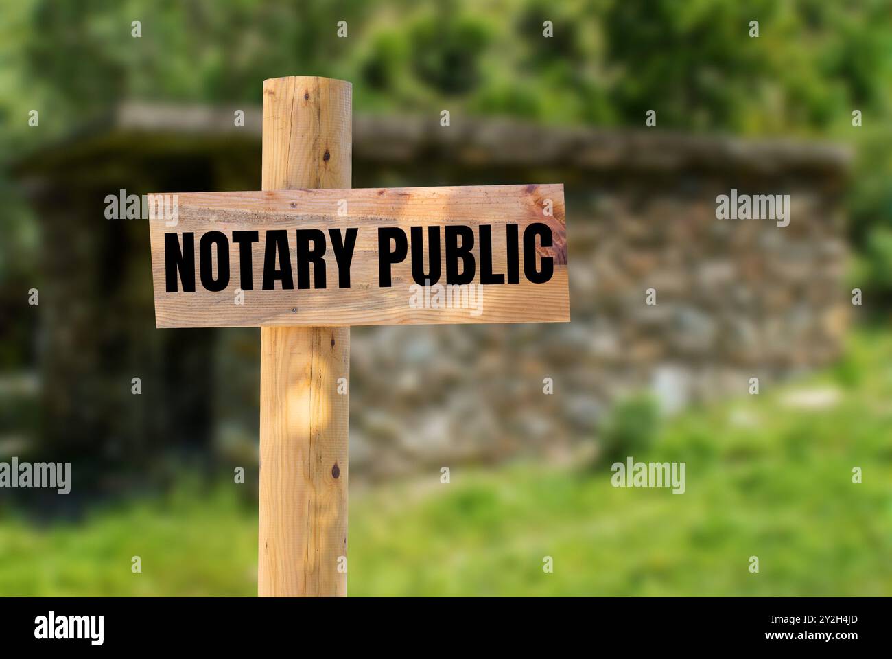 Notary public message written on wooden sign with nature background ...