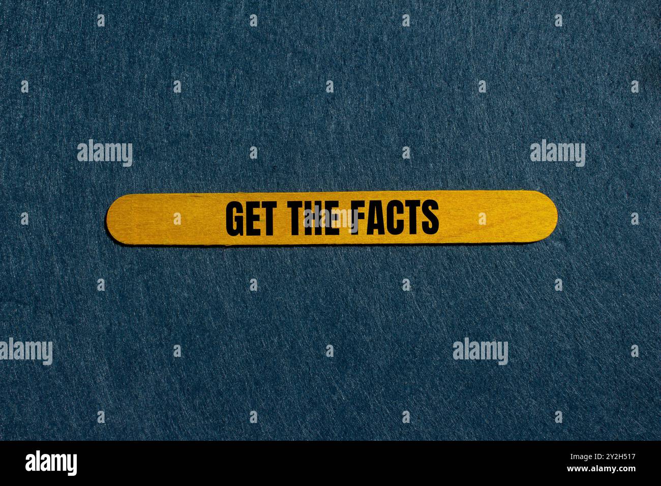 Get the facts message written on yellow wooden stick with gray ...