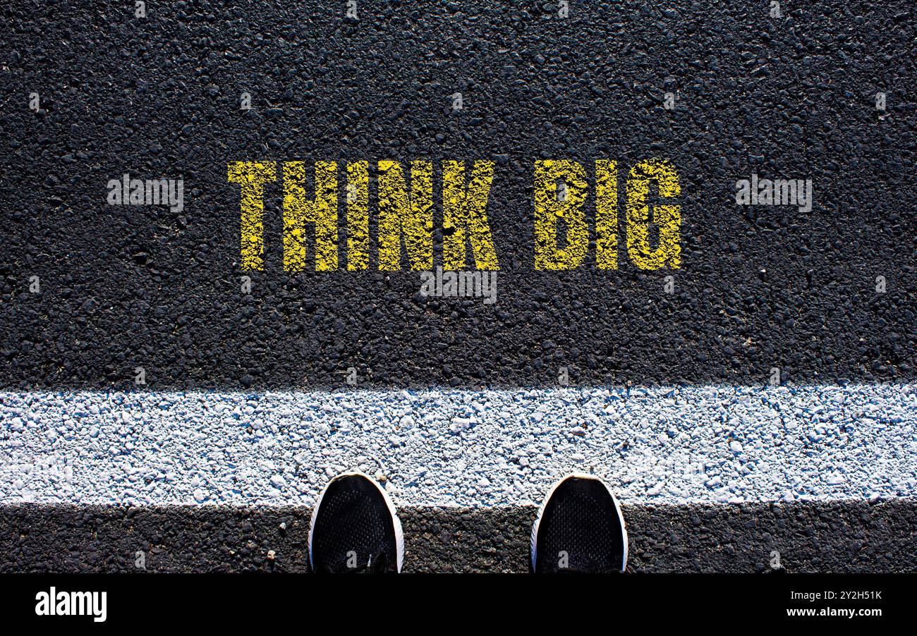 Think big message written on asphalt road. Conceptual think big symbol ...