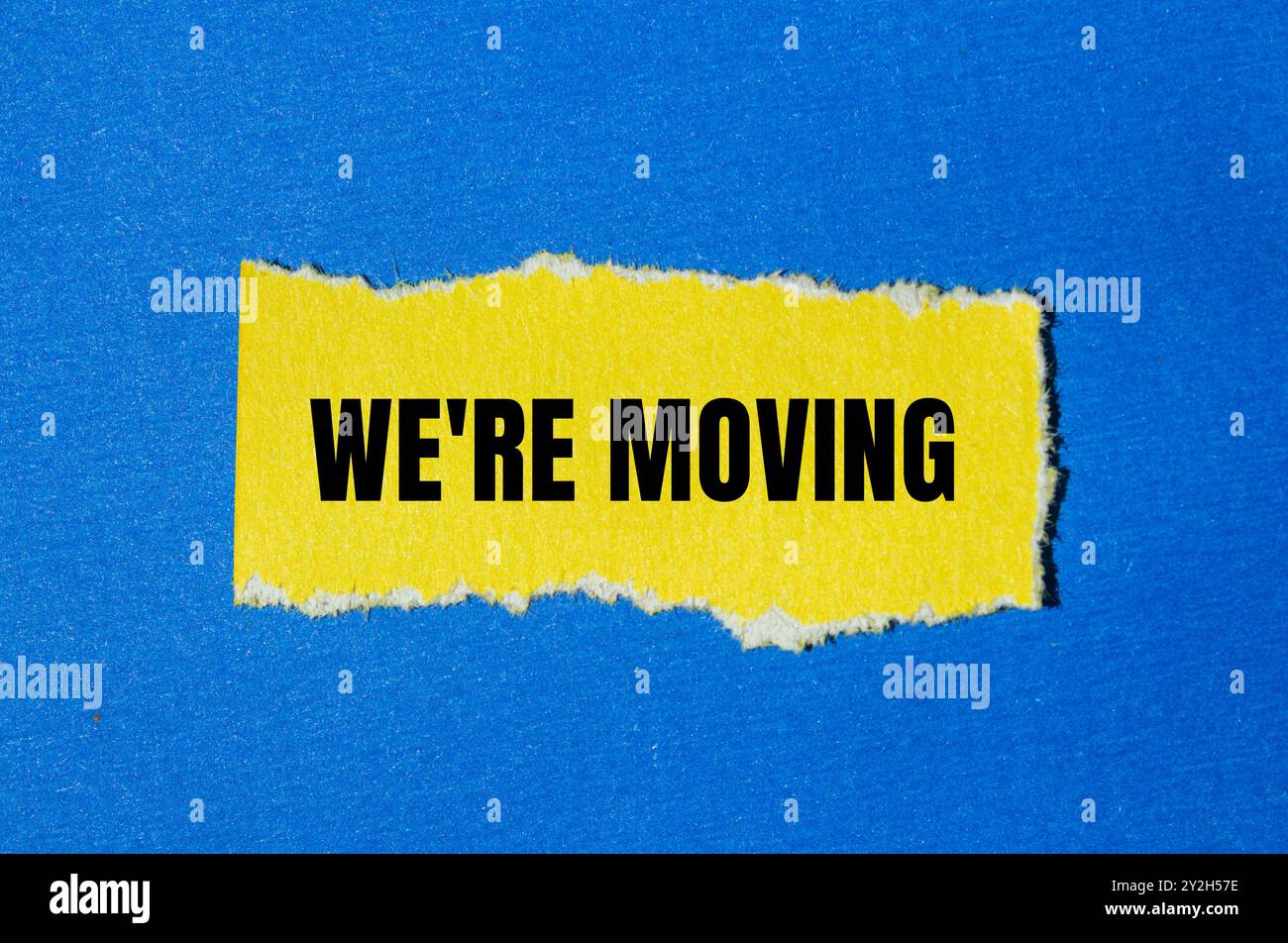 We are moving message written on ripped yellow torn paper piece with ...