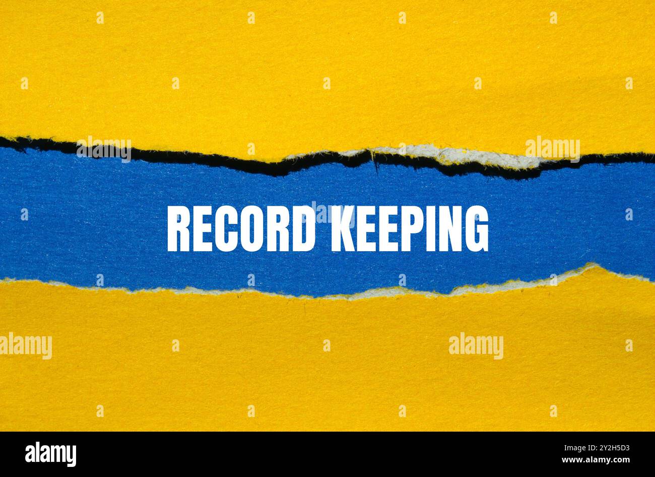 Record keeping message written on ripped torn yellow paper with blue background. Conceptual ...