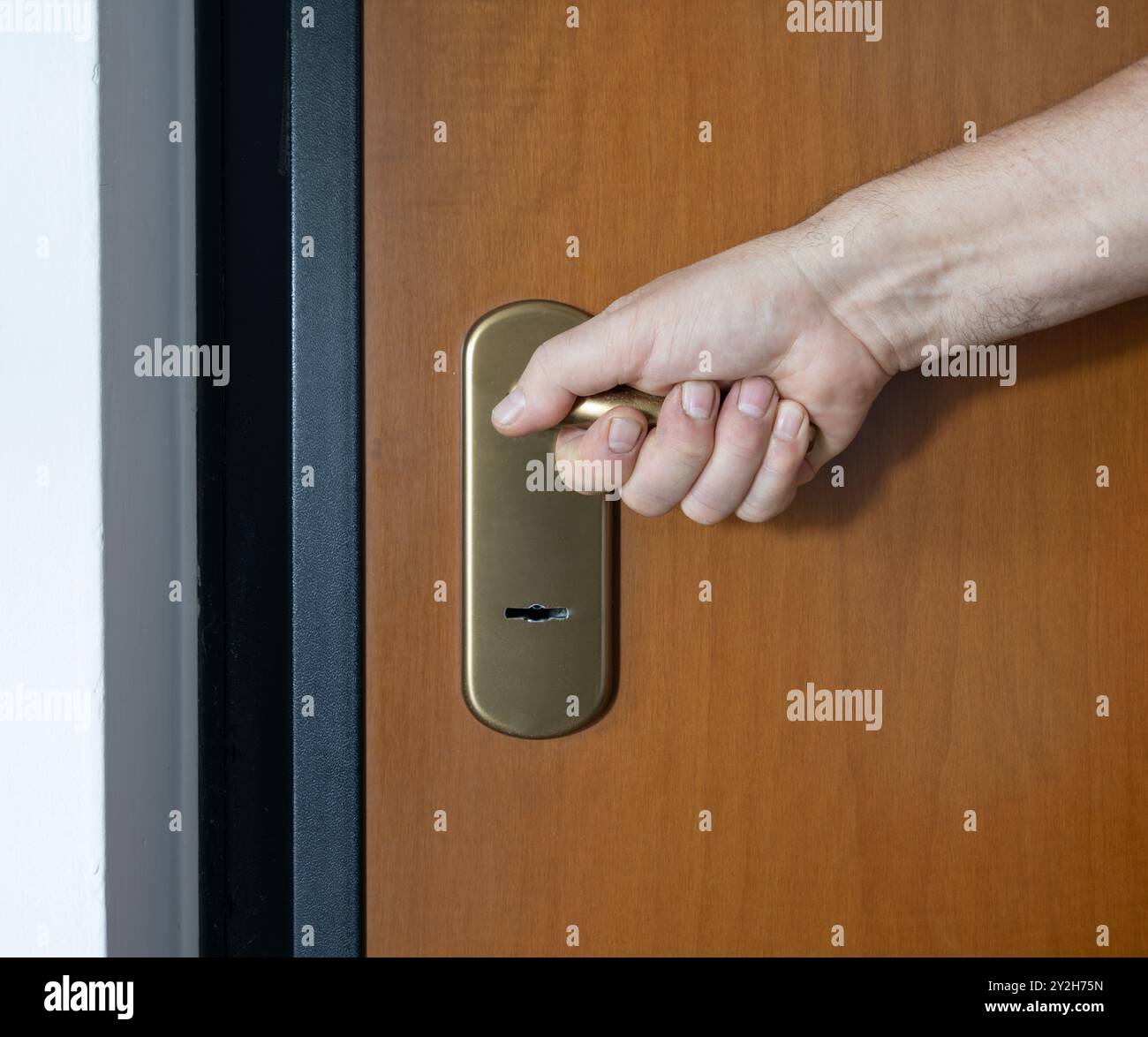 Hand closing entrance door hi-res stock photography and images - Alamy