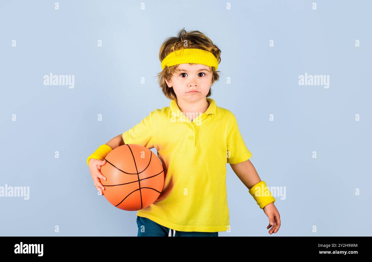Sporty child in sportswear with basketball ball. Fitness, training and ...