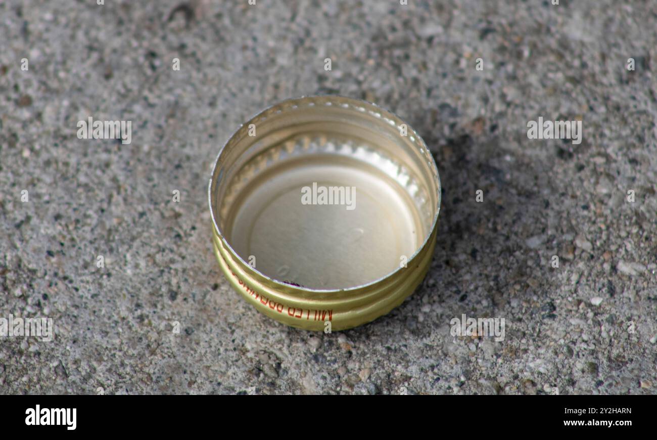 gold bottle cap on pavement ground Stock Photo - Alamy