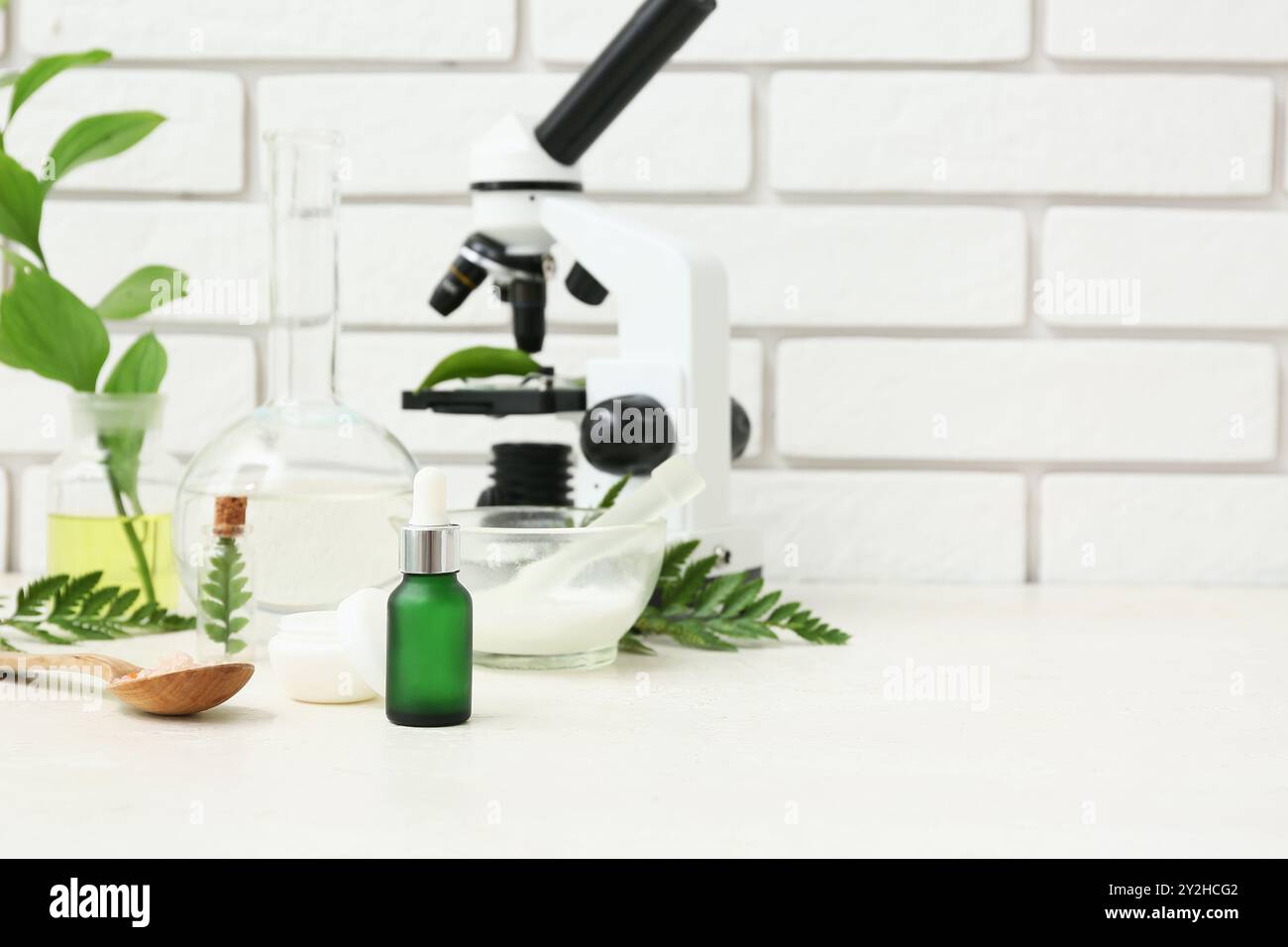 Laboratory glassware and microscope with ingredients for preparing ...