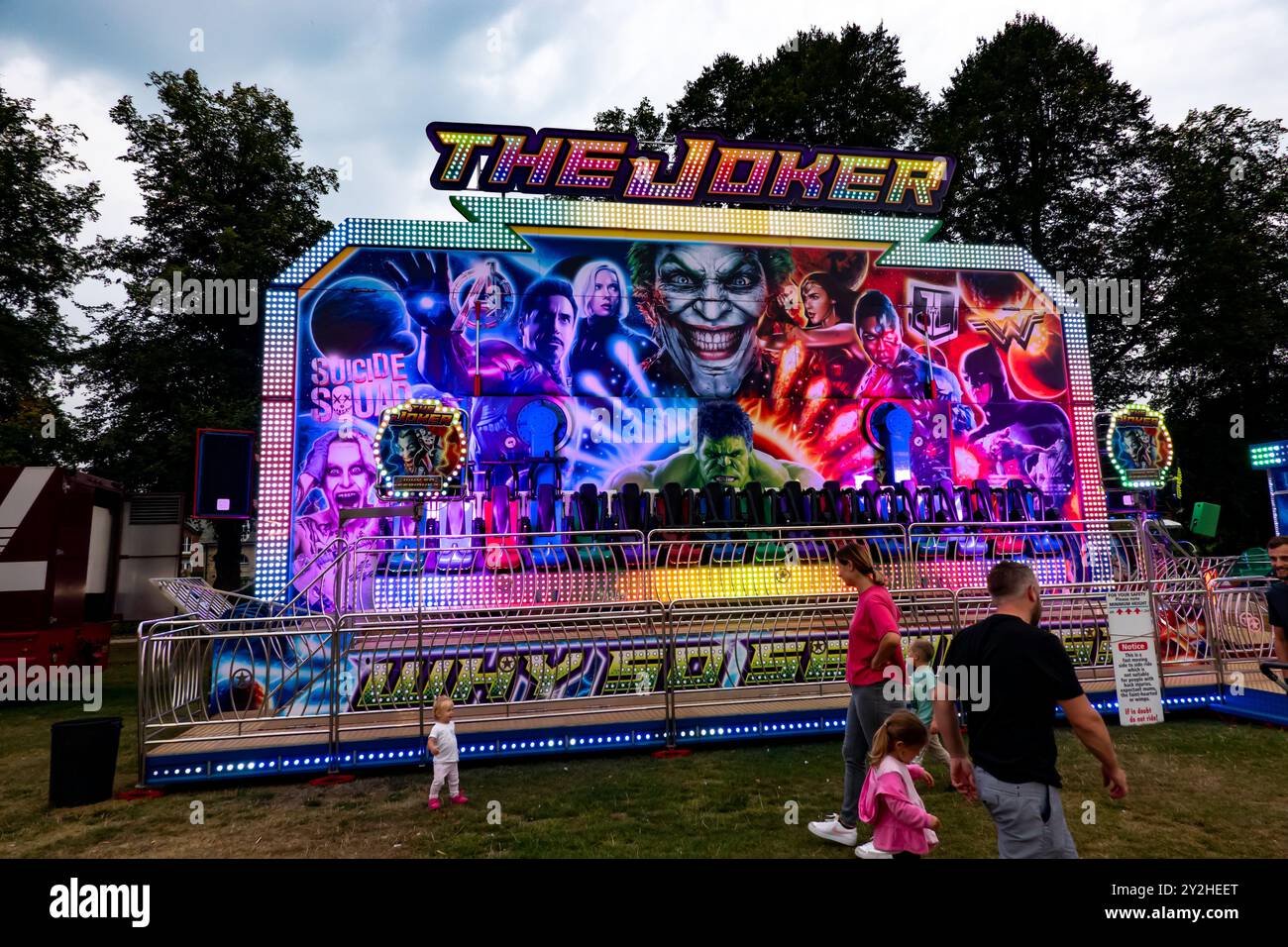 People in front of a thrill ride at a travelling funfair in Saffron ...