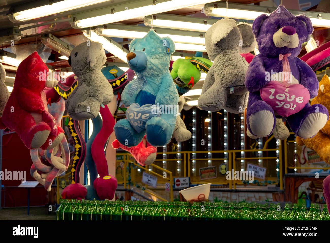Stuffed soft toys hanging on a stall at a travelling funfair Saffron ...