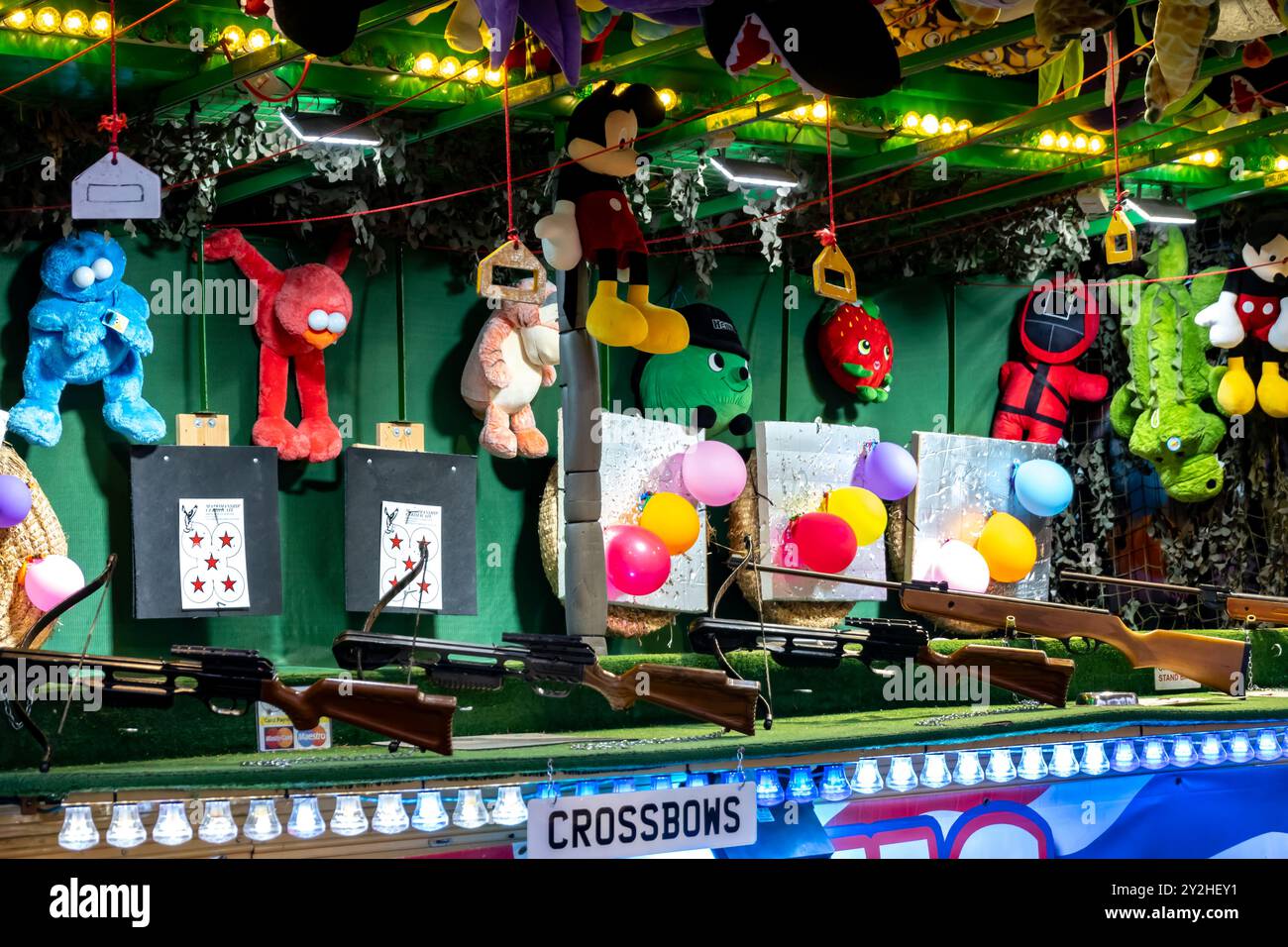 Crossbows and rifles shooting game stall at a travelling funfair at ...