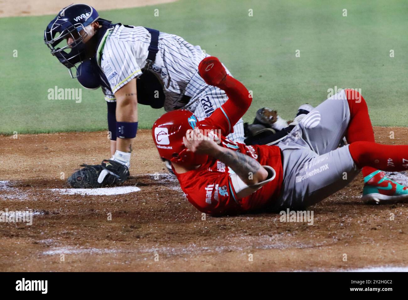 Juan Carlos Gamboa #47 of Diablos Rojos, slides to home against ...