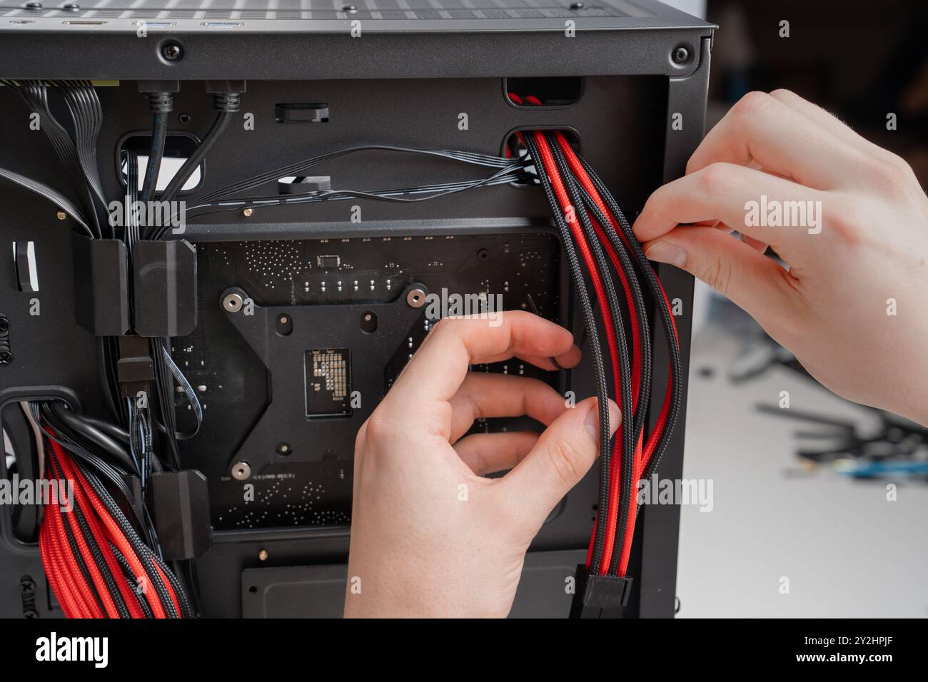 Computer case with motherboard and power supply unit being held open by ...