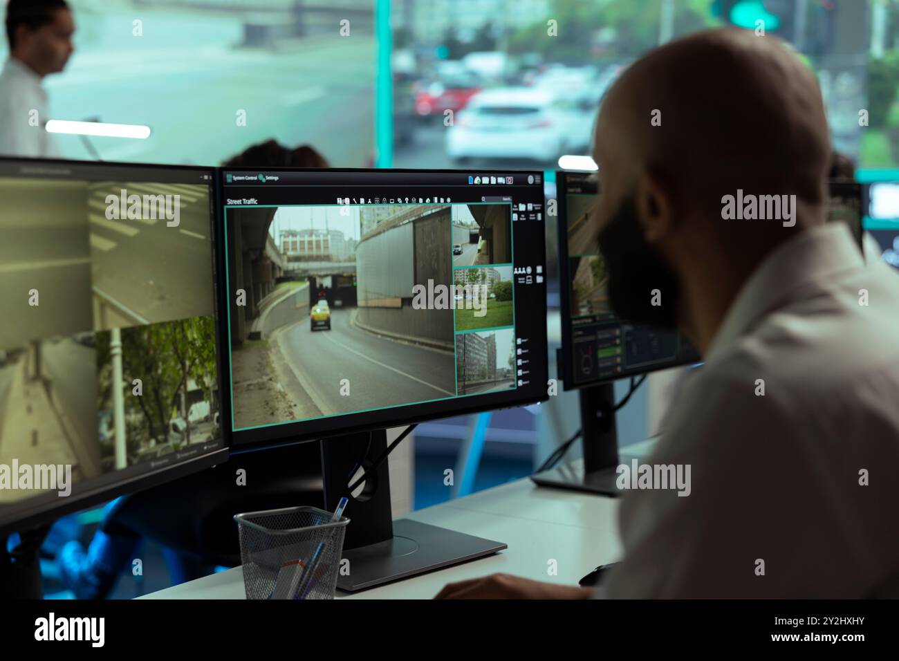 Employee supervising traffic via CCTV surveillance footage around the ...