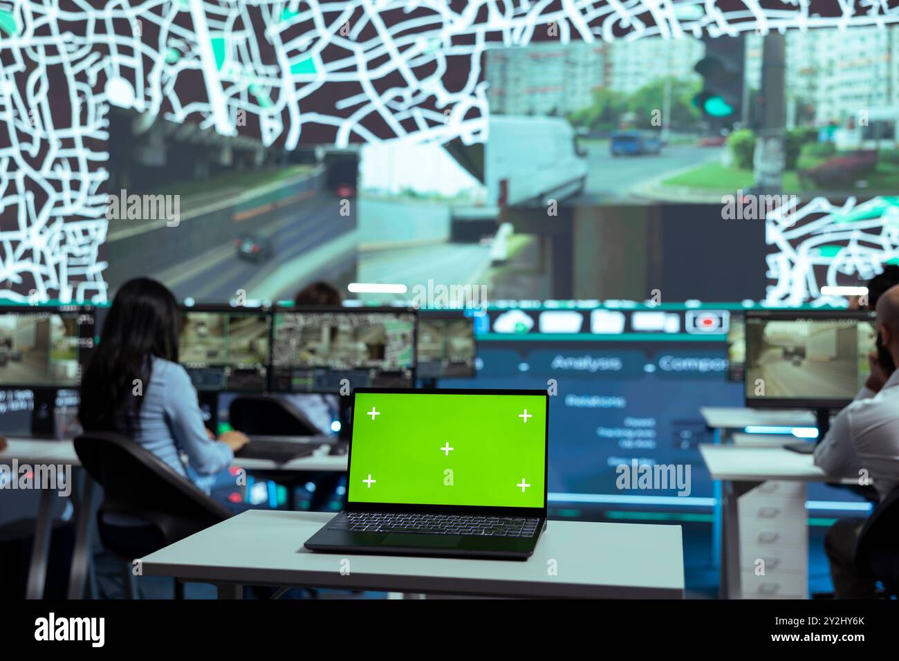 Agency employees look at satellite map and CCTV footage in monitoring ...